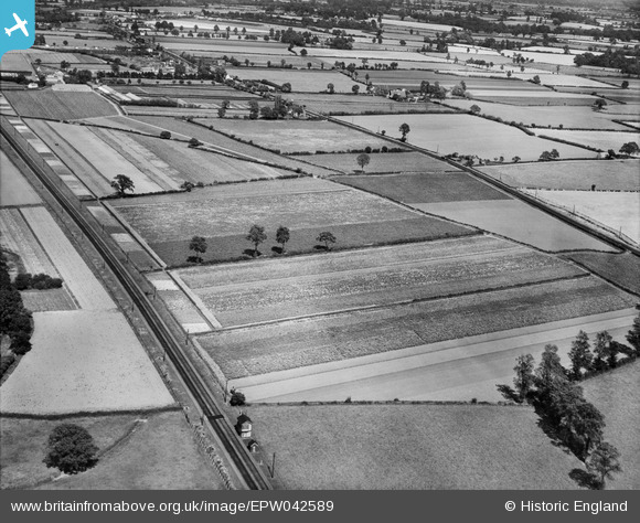 EPW042589 ENGLAND (1933). Fields beside the railway line to the south ...
